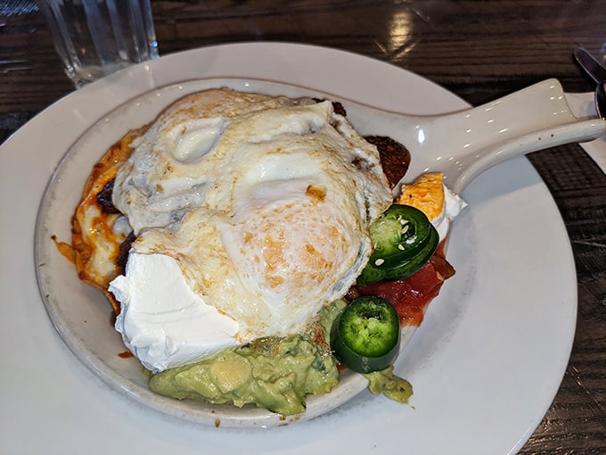 Breakfast with attitude: eggs perched proudly atop a fiesta of flavors, with jalapeños standing guard and avocado cooling things down.