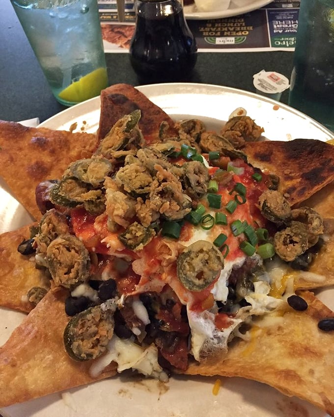 These loaded nachos aren't just a meal, they're an architectural achievement – layers of flavor stacked higher than your weekend to-do list.