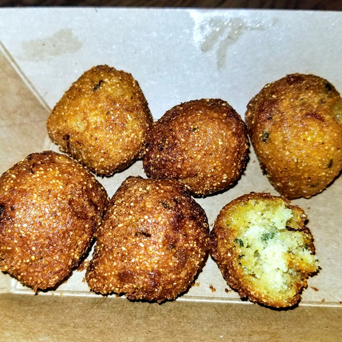 Hush puppies with the ideal crisp-to-tender ratio—little cornmeal grenades of joy that explode with flavor.