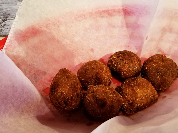 Hush puppies so perfectly golden they should be in a museum—if museums allowed visitors to devour the exhibits with honey butter.