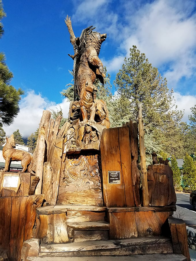 Wood carving elevated to an art form. This towering sculpture tells forest stories in cedar—like a totem pole that graduated from art school.