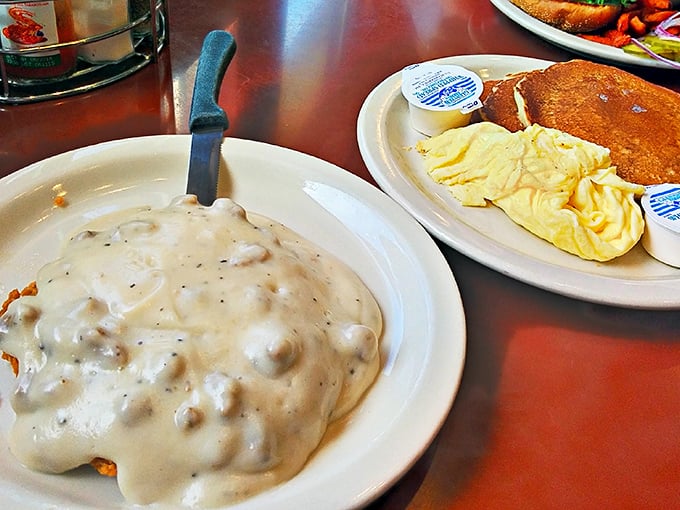 Biscuits and gravy so generously portioned you'll need a snorkel to reach the bottom. This plate doesn't just feed you—it hugs your soul.