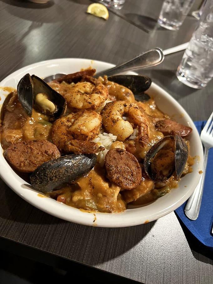 This jambalaya doesn't just simmer—it tells stories of Louisiana bayous while bringing together shrimp, sausage, and mussels in perfect harmony.