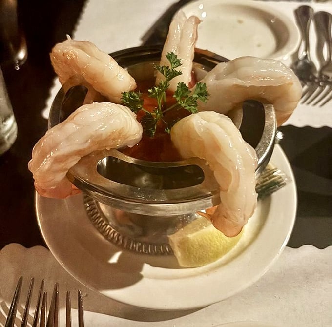 The classic shrimp cocktail – where plump crustaceans hang from a silver pedestal like acrobats, waiting to take a dive into that spicy cocktail sauce below.
