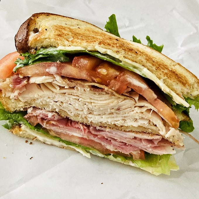 This club sandwich isn't playing around—it's the architectural marvel of lunch, with layers that deserve their own blueprint.