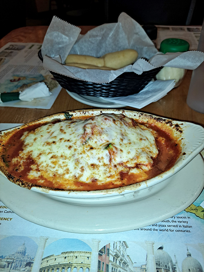 Baked pasta perfection with cheese melted to golden-brown glory. Paired with those fresh breadsticks, it's the comfort food equivalent of a warm hug.