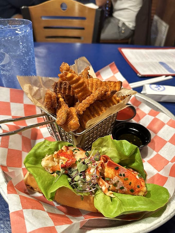 The lobster roll's entourage includes waffle fries and what appears to be seafood's best friend—more seafood. Talk about squad goals.