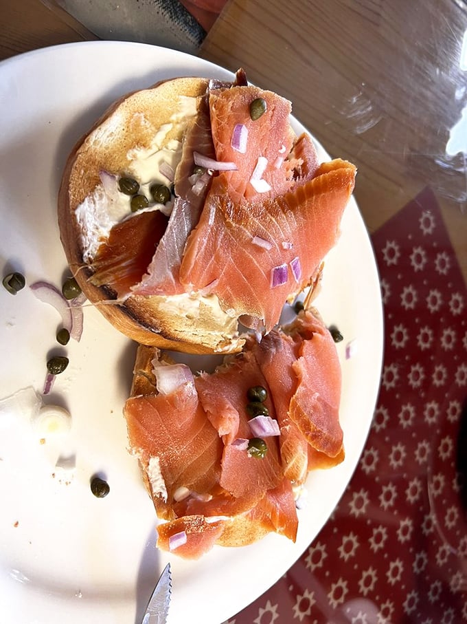 This isn't just a bagel with lox – it's a masterclass in simplicity, where cream cheese, capers, and that house-smoked salmon create perfect harmony on toasted perfection.
