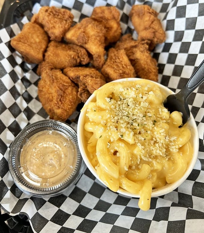 The Nashville Nuggs and mac and cheese combo—golden-fried nuggets beside a creamy, cheesy masterpiece topped with breadcrumbs that whisper, "Diet tomorrow." 