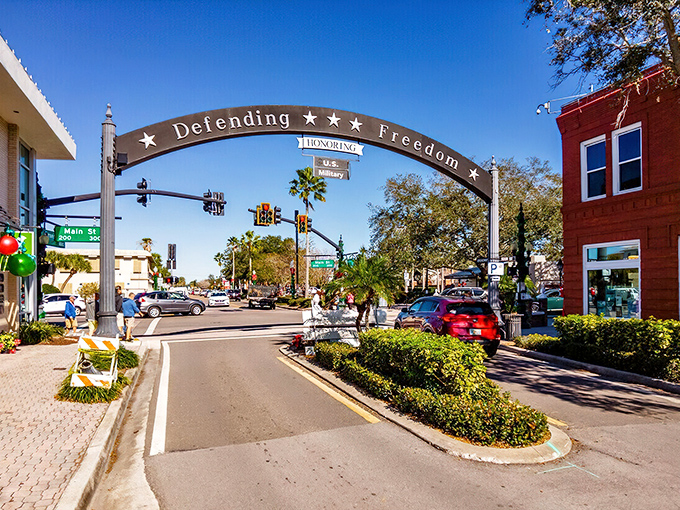 The "Defending Freedom" arch frames Main Street perfectly, like a movie director set-designed this small-town scene for maximum nostalgic impact.