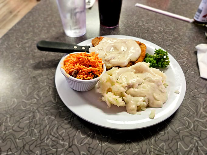 These mashed potatoes aren't just whipped – they're transformed into cloud-like pillows of comfort, blanketed in gravy that could solve world peace.