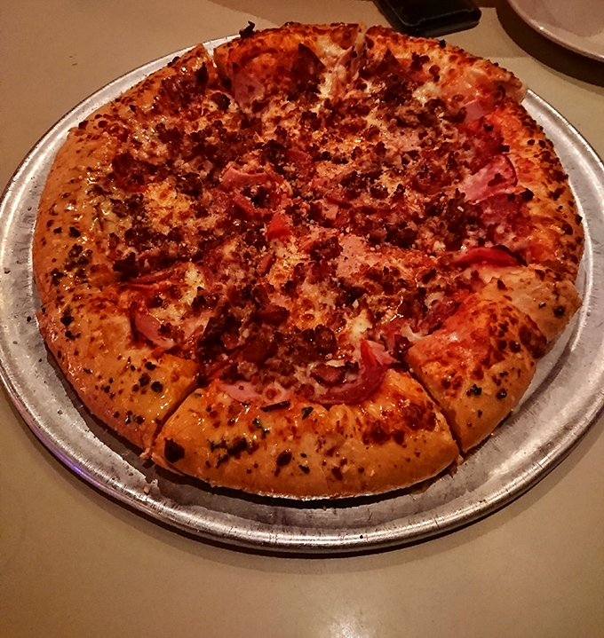 The Meat Lovers isn't just a pizza—it's a protein festival where every bite delivers that perfect harmony of spiced meats and melted cheese.