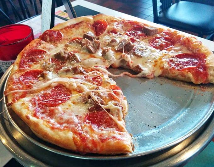 Half-eaten yet fully appreciated—this pepperoni and meatball pizza demonstrates the perfect ratio of cheese stretch to crust chew that pizza scientists have sought for generations.