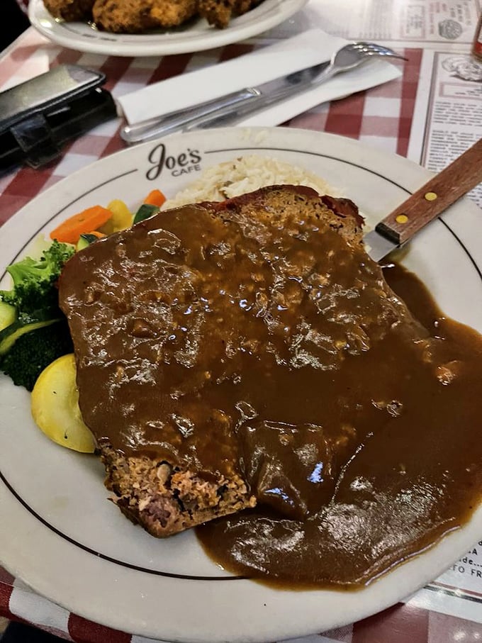 Meatloaf that doesn't apologize for being meatloaf. That rich gravy blanket isn't hiding anything—it's celebrating what lies beneath.