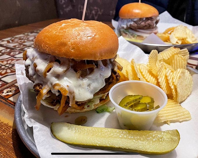 Behold the burger that launched a thousand food pilgrimages—melted cheese cascading over the patty like a dairy waterfall.