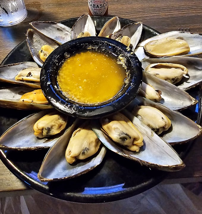 Thursday's mussel special arrives like a sunburst on your table—plump bivalves surrounding liquid gold butter sauce for dipping.