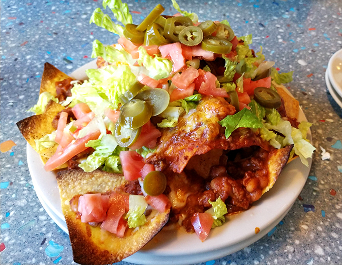 These nachos don't understand the concept of personal space. Loaded with toppings and refusing to leave any chip naked—just as it should be.