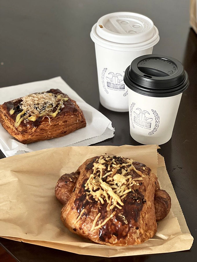 Pastry paradise on display. These chocolate-drizzled beauties aren't just baked goods—they're the reason alarm clocks were invented.