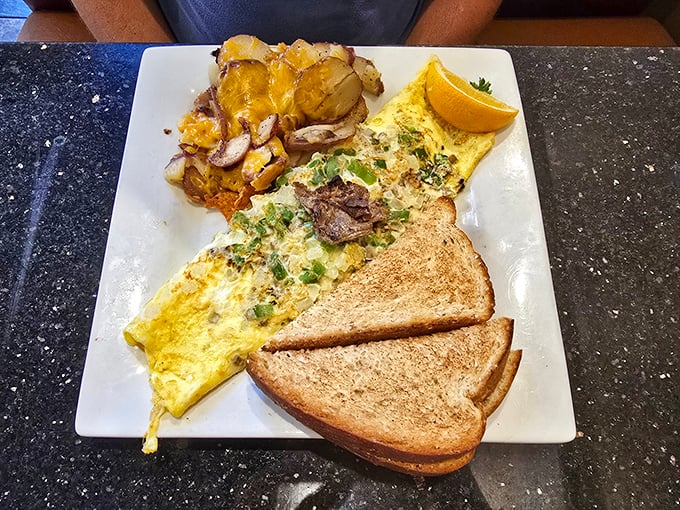 This omelet doesn't just contain ingredients—it showcases them. Like a Broadway production where eggs get the starring role.