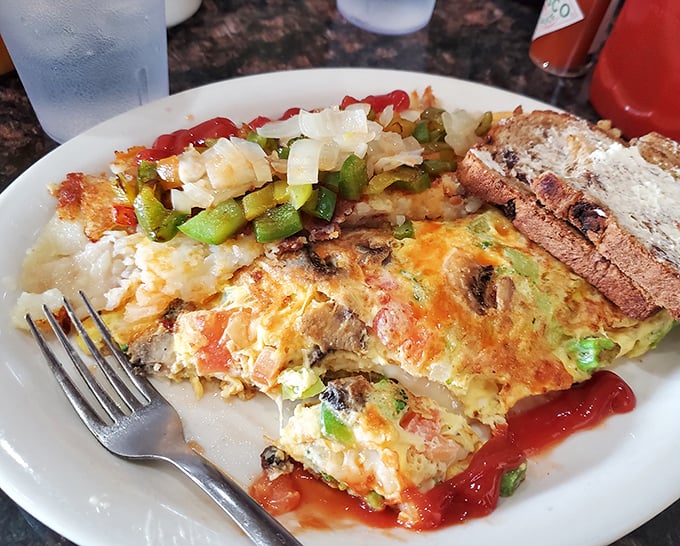 This isn't just an omelet—it's a colorful canvas of breakfast possibilities. The kind of morning masterpiece that makes you rethink hitting the snooze button.