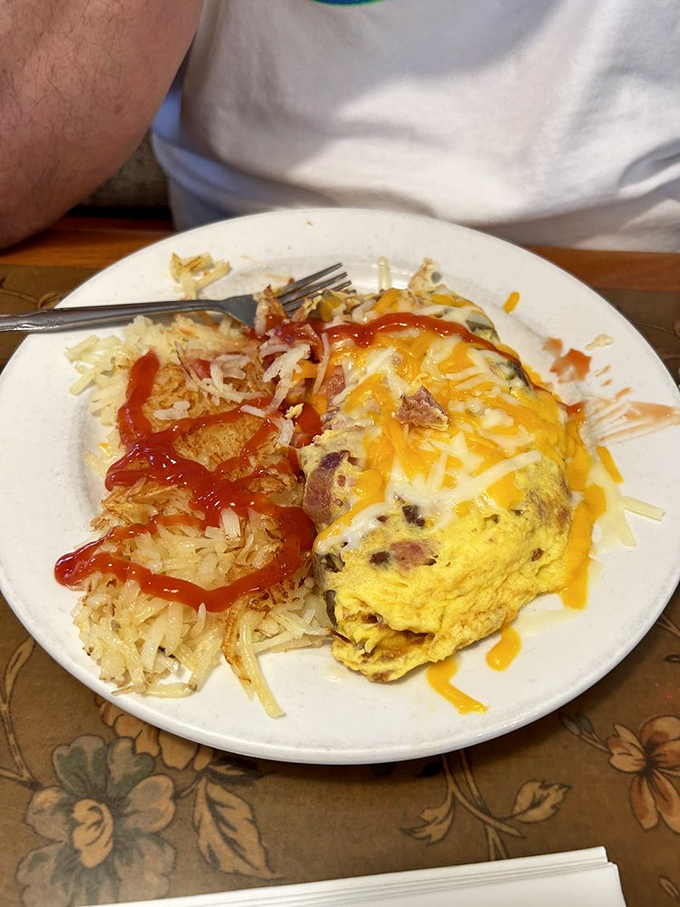 This fluffy omelette stuffed with goodness and crowned with melted cheese sits beside hash browns worthy of their own fan club.