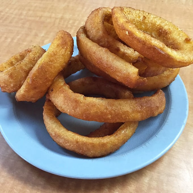Golden halos of crispy perfection. These onion rings aren't just a side dish—they're the supporting actors that steal the show.