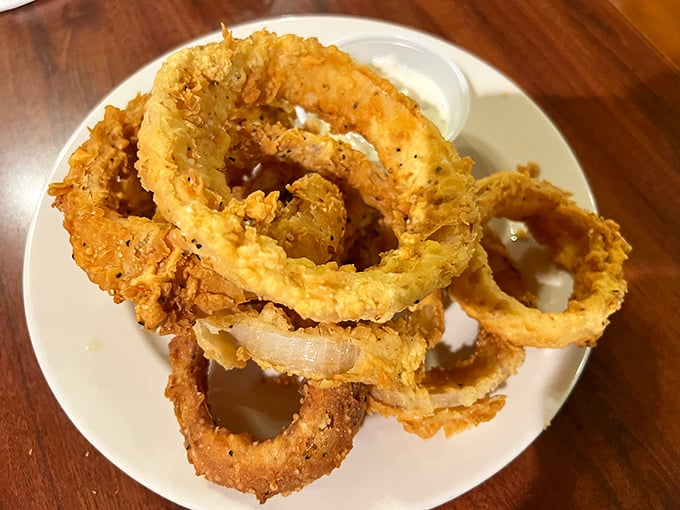 These aren't just onion rings—they're golden halos of happiness, crispy enough to make you forget your table manners.