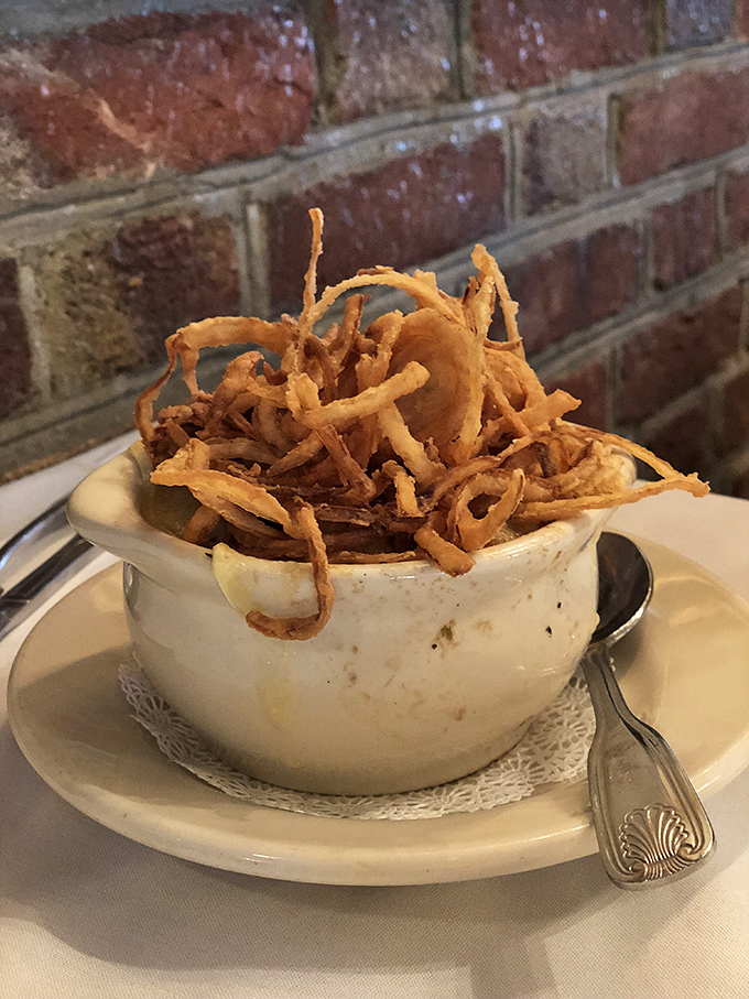 French onion soup that's wearing its cheese crown with pride—a bowl of comfort that makes you wonder why anyone bothers with fancy molecular gastronomy.