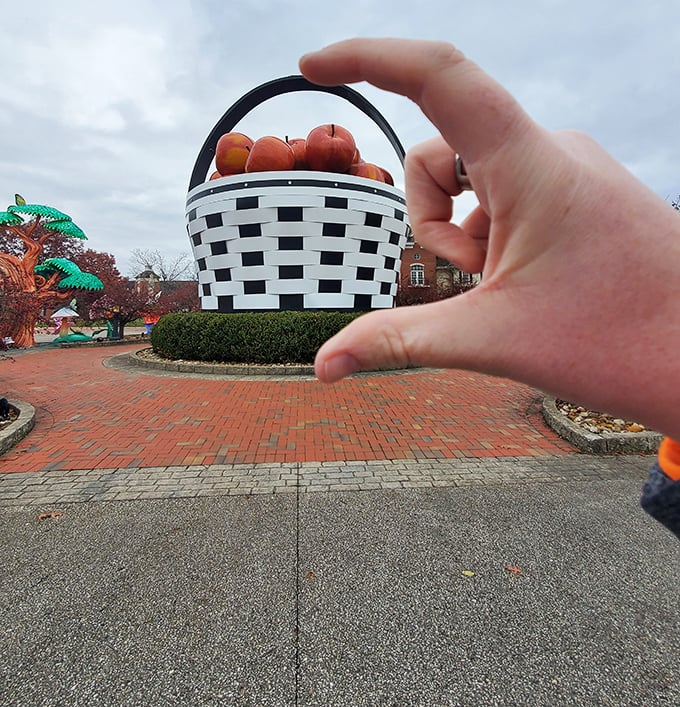 "Just pinching the world's largest basket!" Forced perspective photography turns visitors into giants playing with this not-so-miniature roadside marvel.
