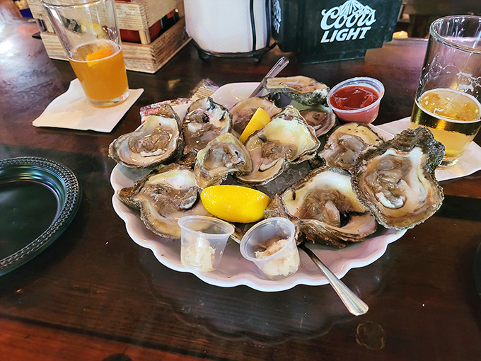 Oysters arranged like a pearl necklace, glistening with briny promise. The lemon wedges aren't garnish—they're essential supporting actors.