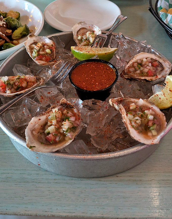 Fresh oysters on ice with zesty salsa—the ocean's perfect gift, elevated by a squeeze of lime and a dash of culinary magic.