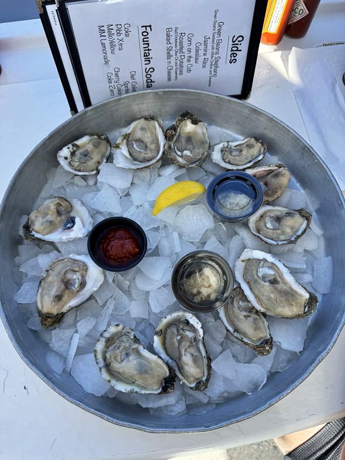A dozen glistening oysters on ice—nature's perfect appetizer. Three dipping sauces because sometimes even perfection can be enhanced.