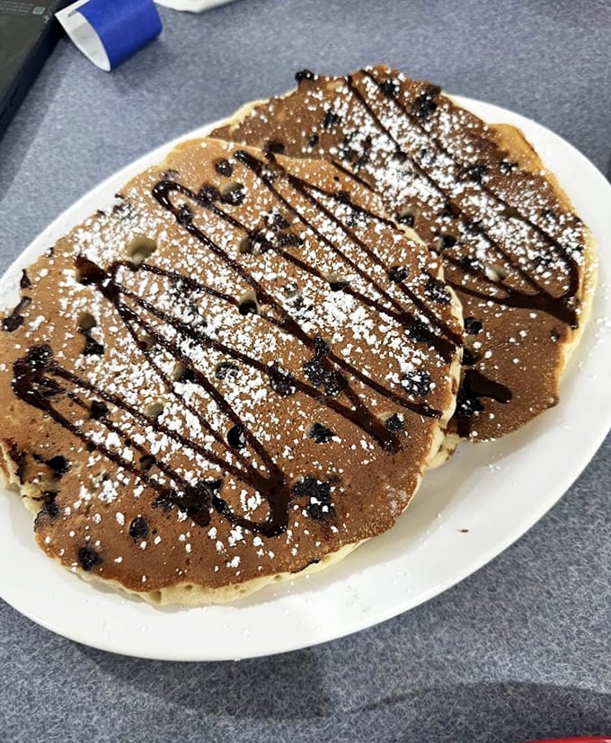 Chocolate chip pancakes with powdered sugar snow - breakfast dessert that makes dieting seem utterly pointless.