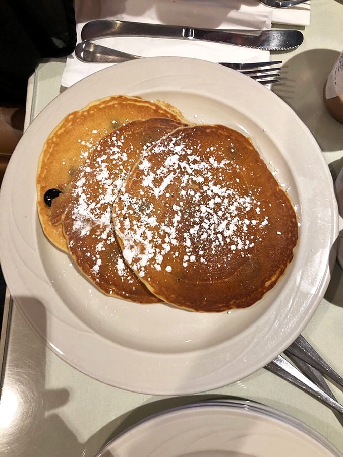 Pancakes dusted with powdered sugar that look like they belong in the Breakfast Hall of Fame – fluffy enough to use as pillows.