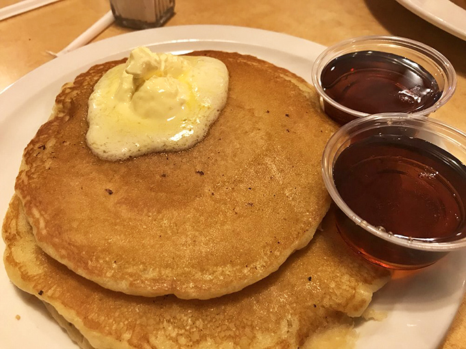 Pancakes so fluffy they could double as pillows, topped with butter melting into that perfect golden landscape. Nap not included.