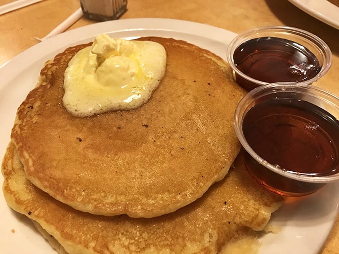 Pancakes so fluffy they could double as pillows, topped with butter melting into that perfect golden landscape. Nap not included.