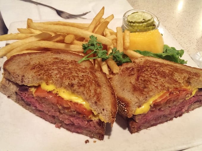 The patty melt – that glorious hybrid where burger meets grilled cheese in a sandwich that makes you wonder why you'd ever order them separately.