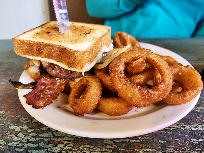 The patty melt here doesn't just melt cheese – it melts hearts with those perfectly crisped edges and gooey center.