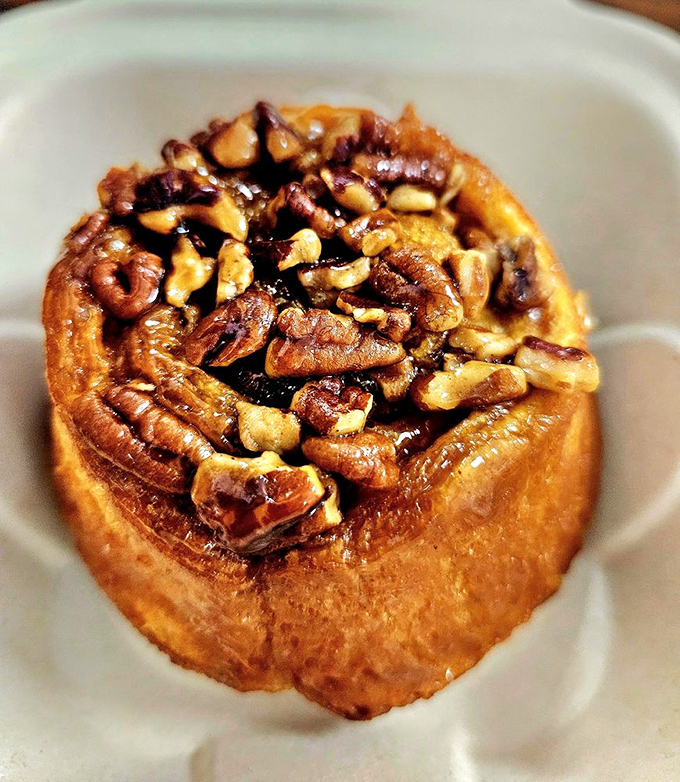 This sticky bun isn't just dessert pretending to be breakfast – it's dessert proudly declaring itself worthy of morning status.