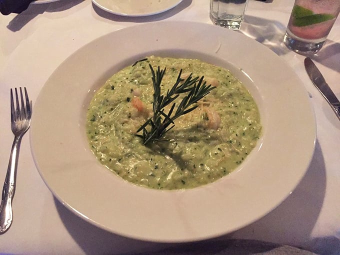 This pesto risotto isn't just green—it's money. The fresh rosemary sprig stands like a victory flag over creamy, herb-infused perfection.