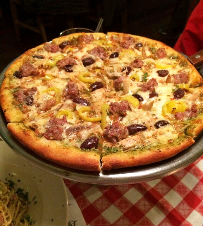 Pizza that makes you question why you ever settled for delivery—topped with Italian sausage, banana peppers, and olives that actually taste like olives.