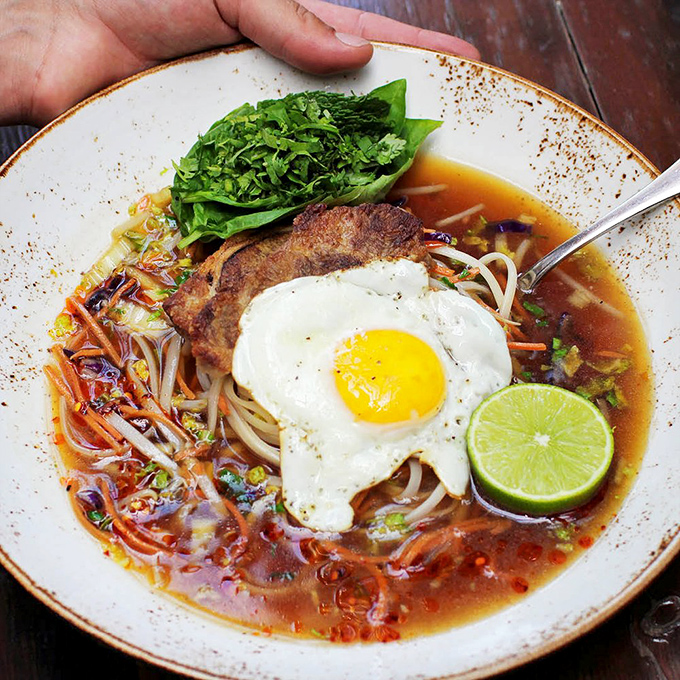 A symphony in a bowl—this Asian-inspired creation balances noodles, broth, fresh herbs, and that perfectly runny egg that makes everything better.