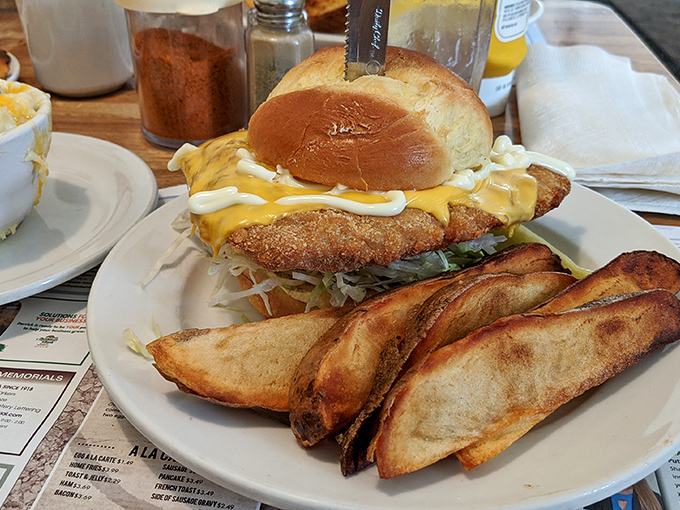 A sandwich that requires both hands and a strategy, this pork tenderloin is flanked by potato wedges that could start their own fan club.