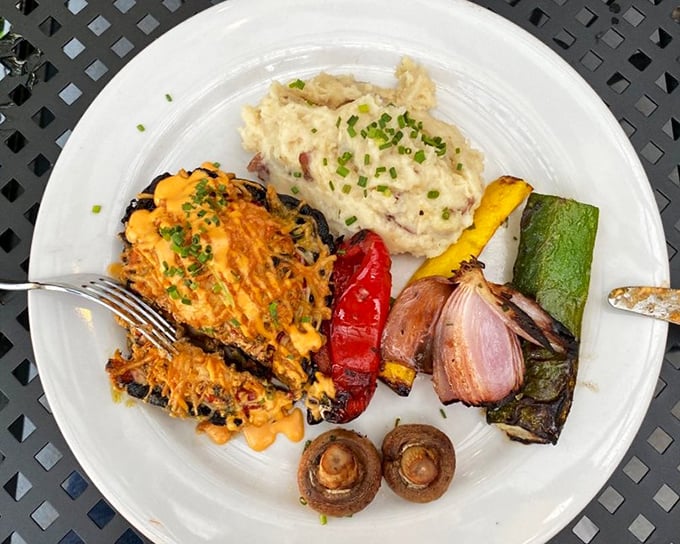 A feast for the eyes and palate—grilled portabella mushroom alongside colorful roasted vegetables and creamy mashed potatoes that comfort the soul.
