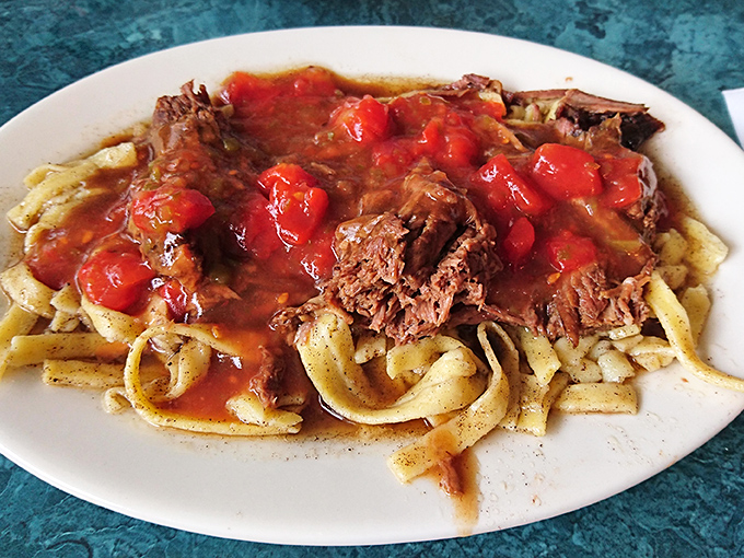 Homestyle butter noodles topped with pot roast and stewed tomatoes—proof that sometimes the most unforgettable meals aren't trying to be Instagram famous.