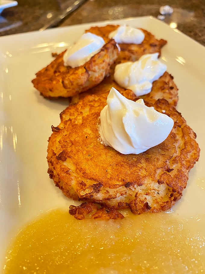 Golden-brown potato pancakes with dollops of sour cream—crispy edges giving way to tender centers. Latke perfection that would make bubbes everywhere proud.