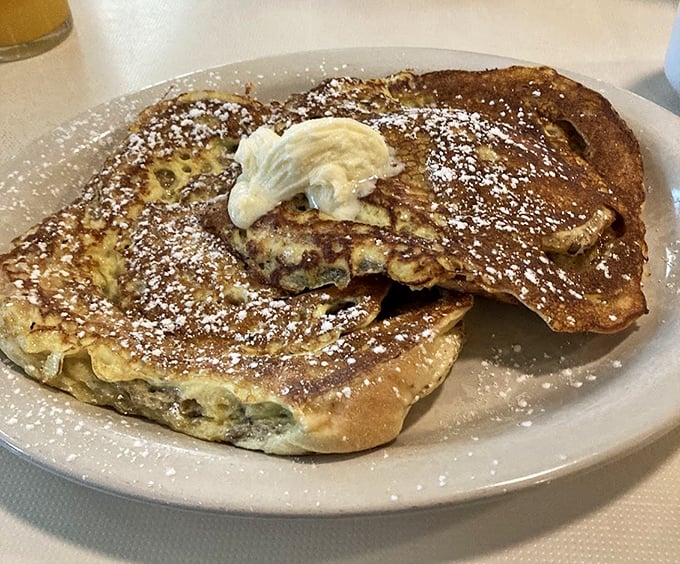 These potato pancakes deserve their own fan club. Dusted with powdered sugar and topped with a dollop of butter—carb heaven has never looked so good.