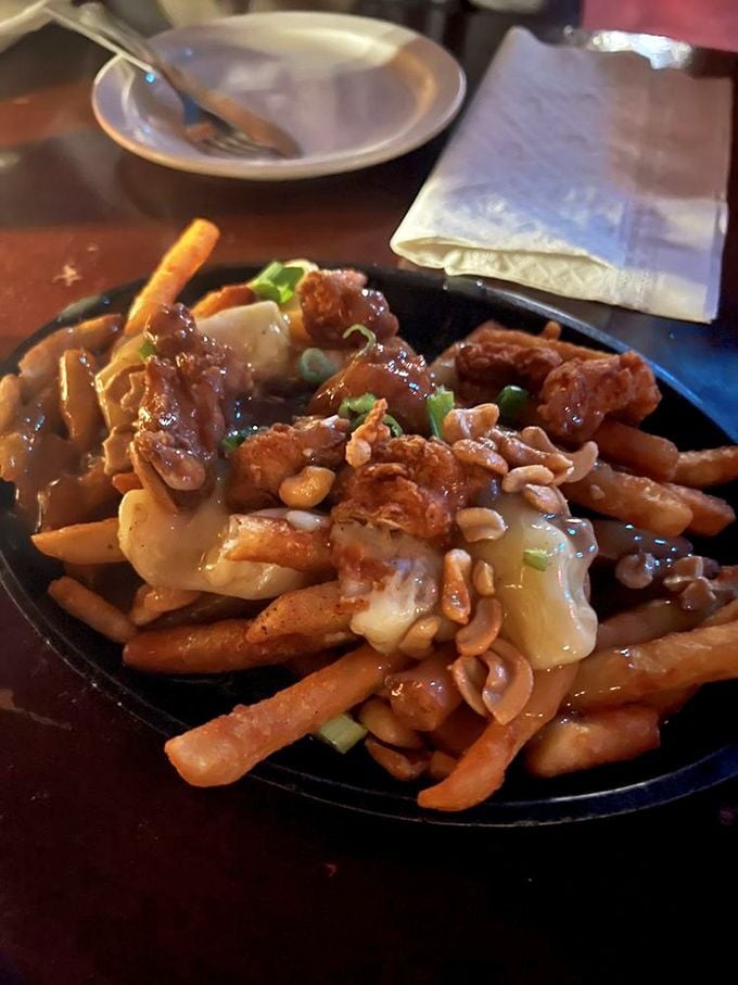 Poutine with purpose. French fries swimming in savory gravy, topped with cheese curds and what appears to be crispy bits of heaven.