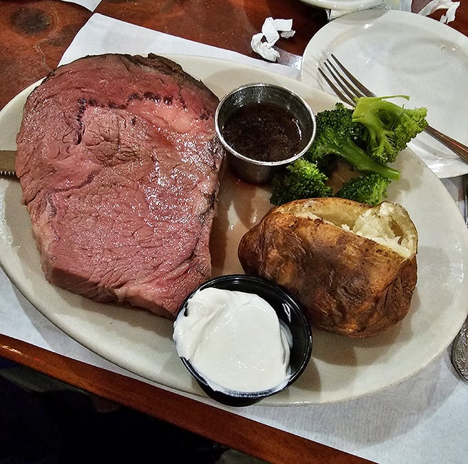 Prime rib so perfectly pink it could make a vegetarian question their life choices, accompanied by a baked potato that's seen the inside of a real oven.