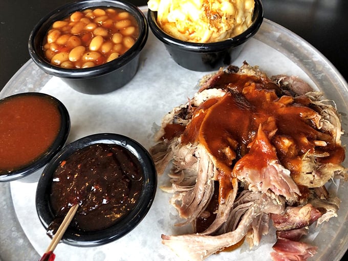 A pulled pork platter with sides that aren't afterthoughts. This tray represents the balanced diet of champions—meat and more meat, with beans for color.